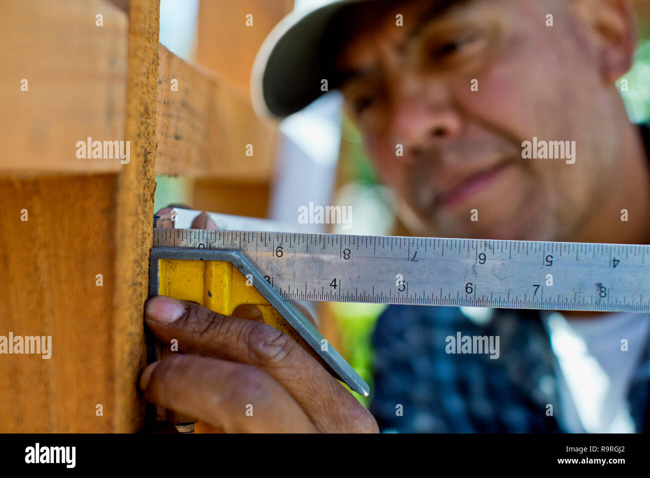 Builder putting down a hammer on a building site Stock Photo - Alamy