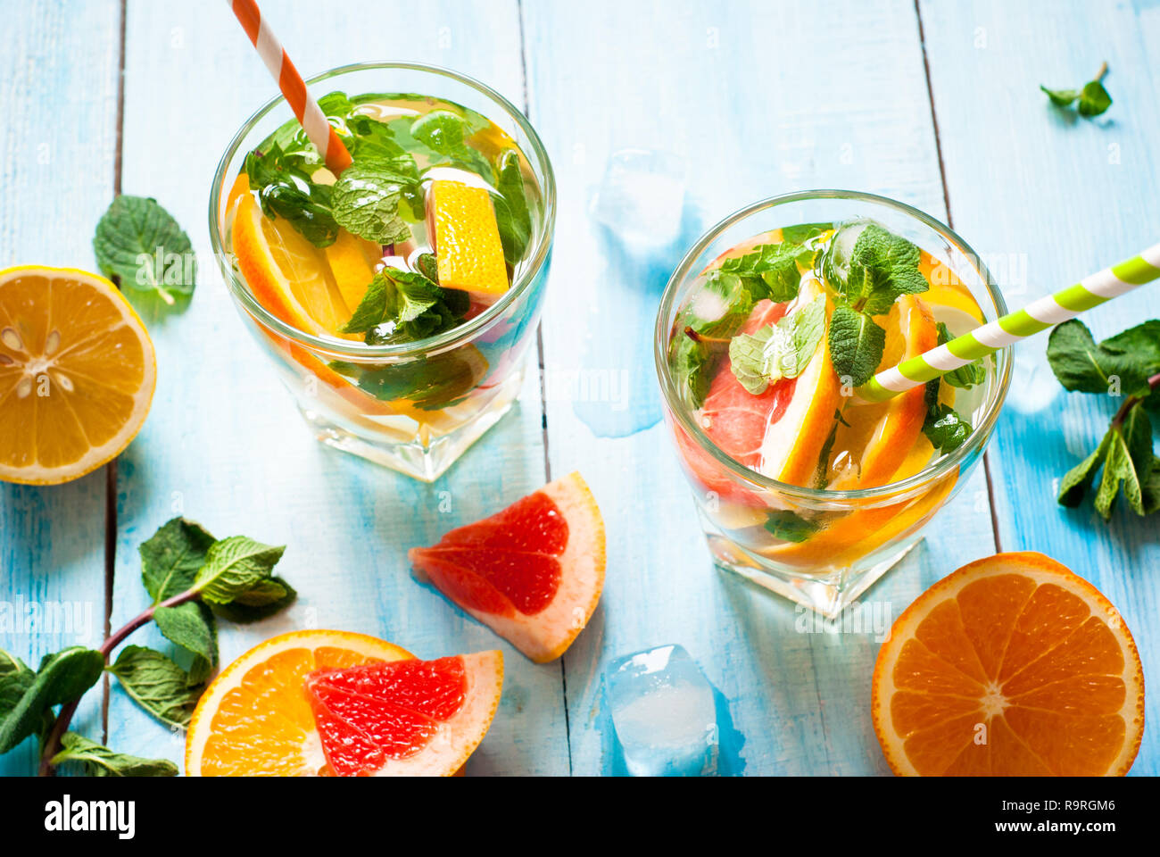 Ice citrus drink with lemon, orange, grapefruit and mint at blue Stock ...