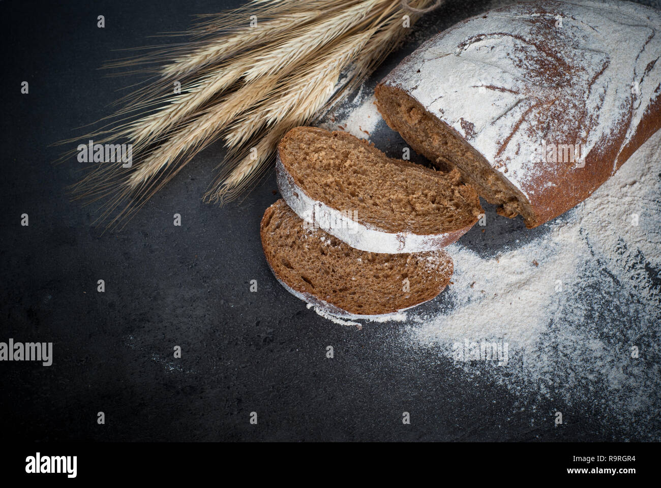 Homemade whole grain bread on a dark background Stock Photo - Alamy