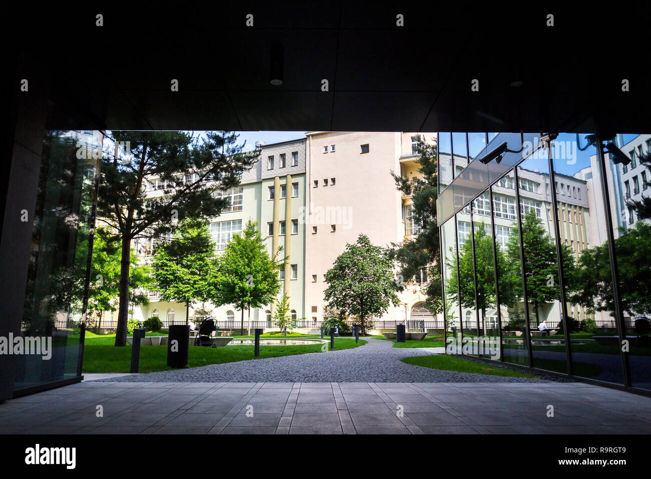 Public park between modern office buildings, future of work, coworking ...