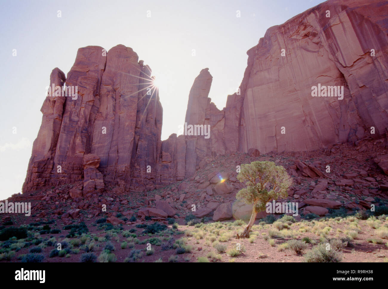 Sun shining behind large eroded rock formations in the desert Stock ...