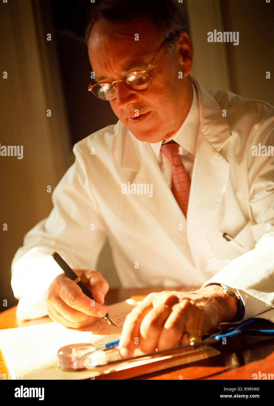 Portrait of a doctor writing on a notepad Stock Photo - Alamy