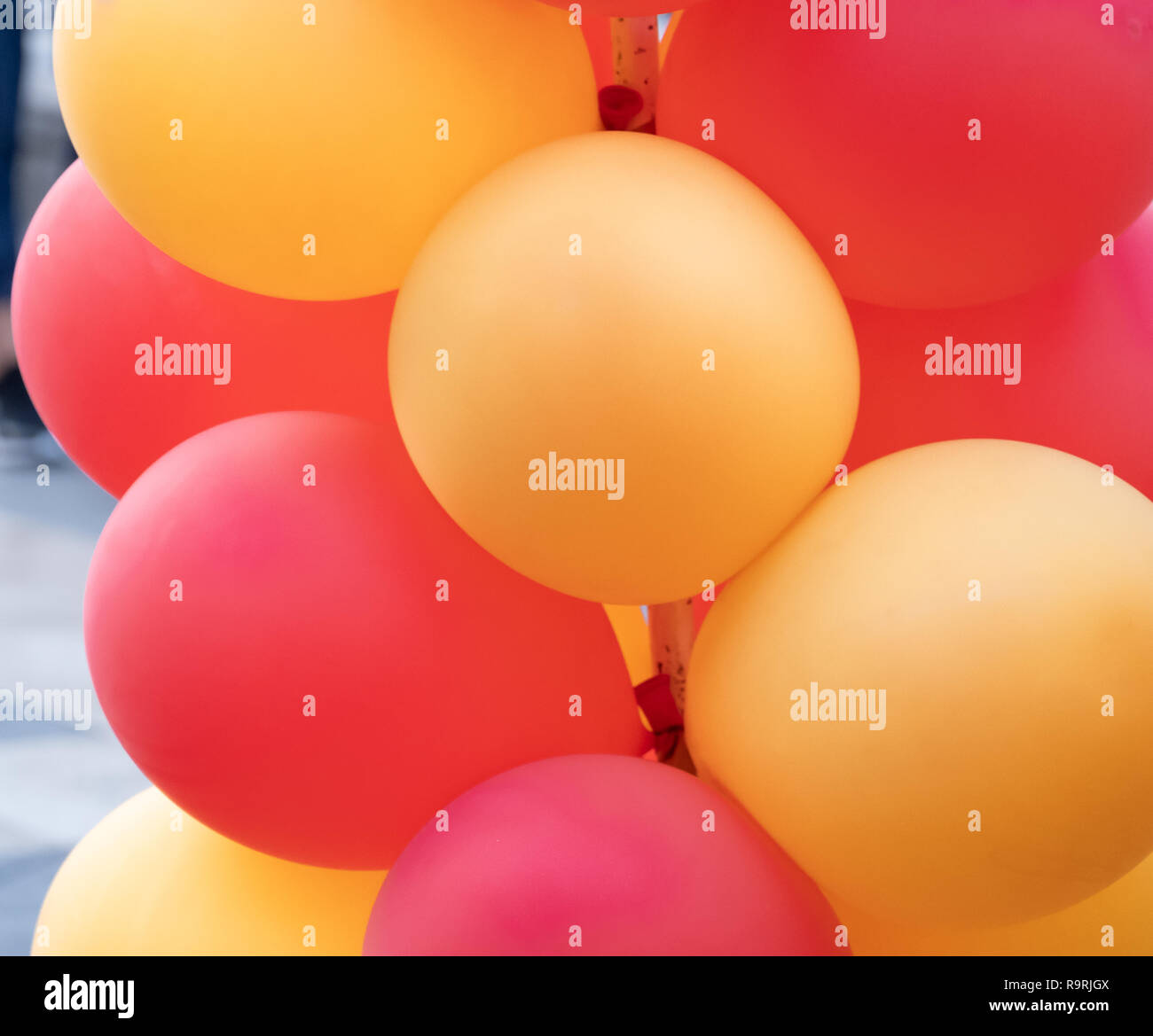 Detail of a row of red and yellow balloons with a side view. Horizontal ...