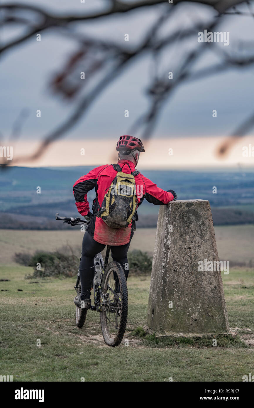Cyclist looking over countryside Stock Photo - Alamy
