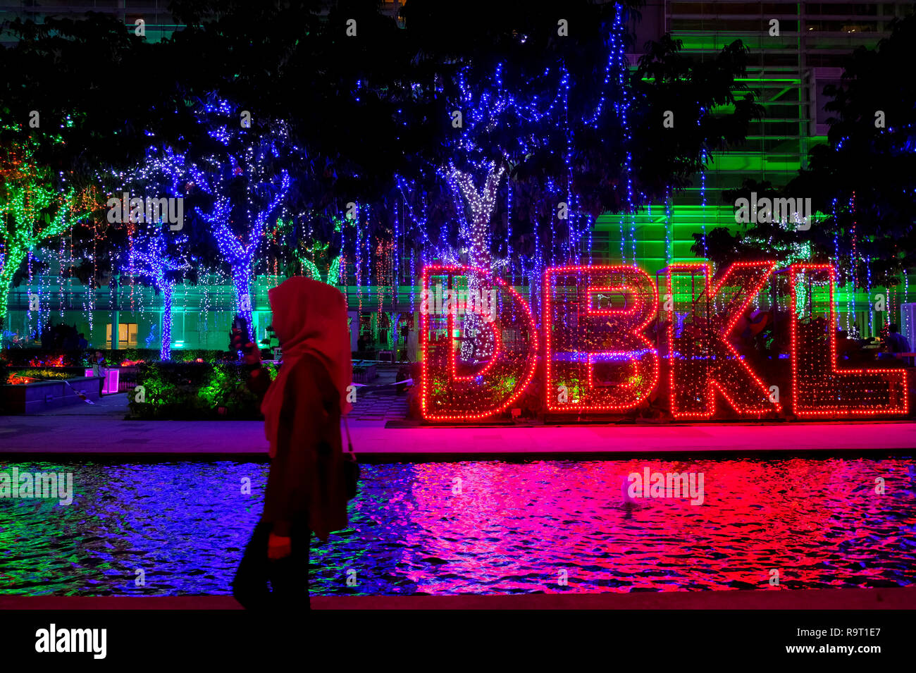 A lady seen walking by a colorful DBKL sign at Light and Motion ...