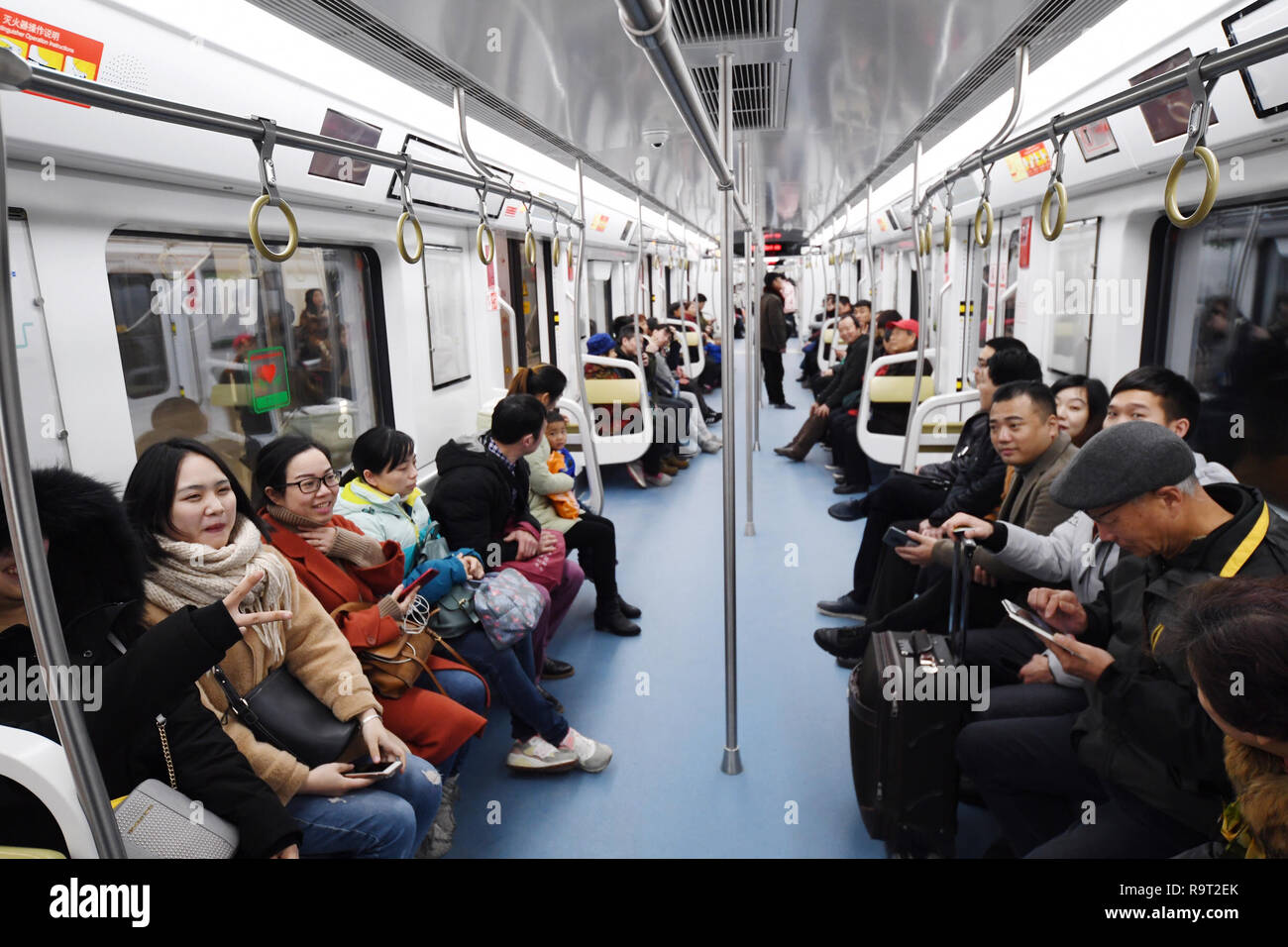 Chongqing. 28th Dec, 2018. Passengers board a rail transit train in ...
