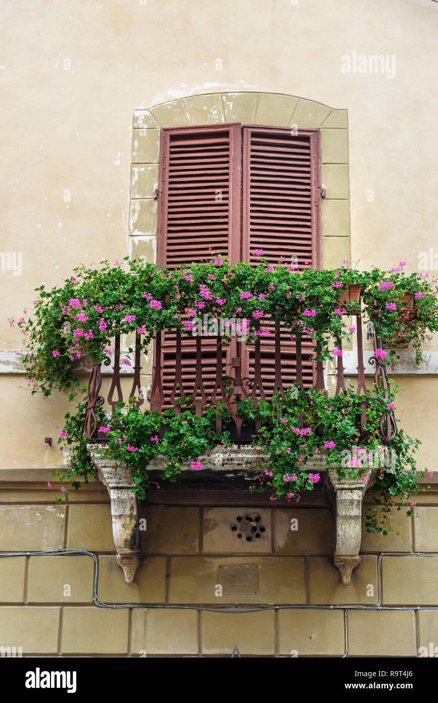 Traditional window and balcony with wooden shutters of old house in ...