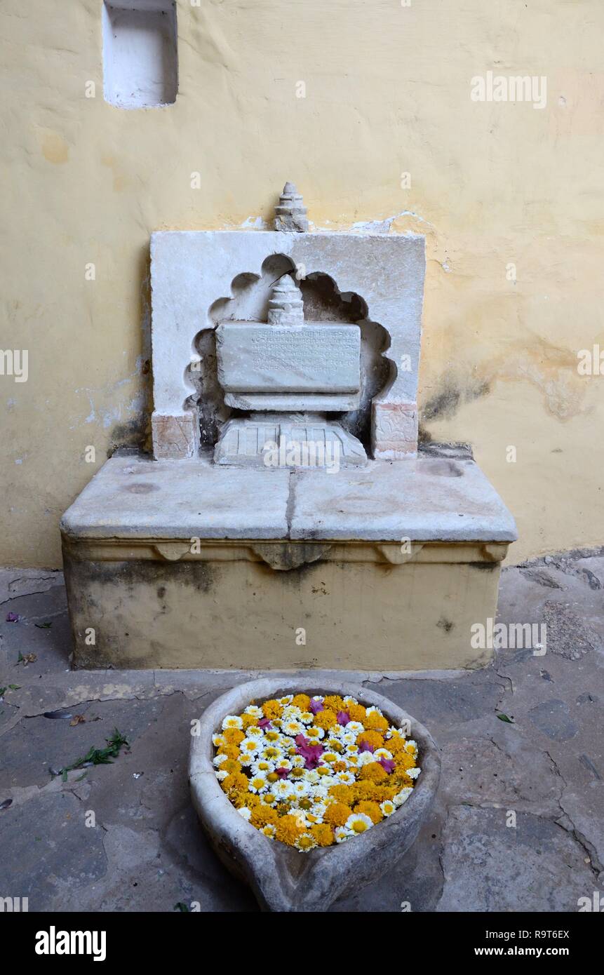 Small Hindu Shrine with chrysanthemums in the garden of an old Indian ...
