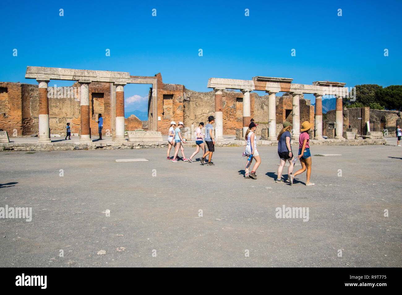 Tourists visiting Roman Forum, Colonnade, Pompeii, Campania Italy ...