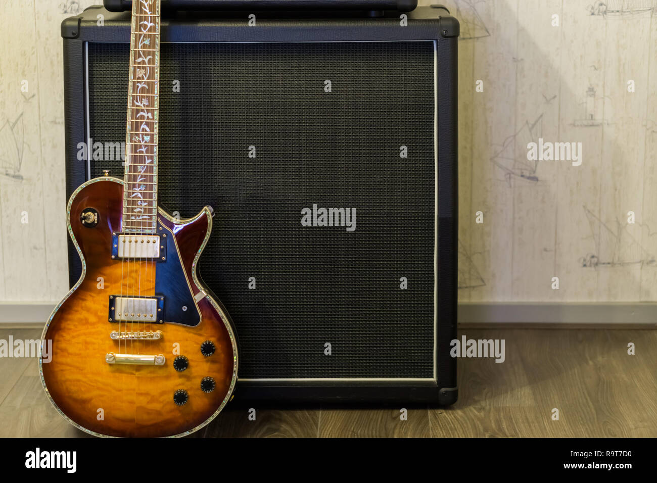 modern sunburst electric guitar standing in front of amplifier ...
