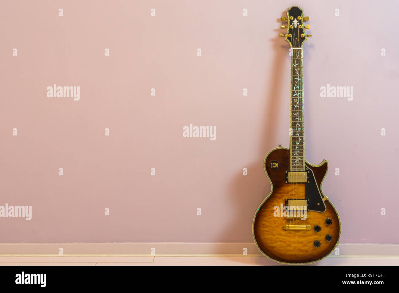 modern electric guitar with tree of life neck inlay, isolated on stone ...