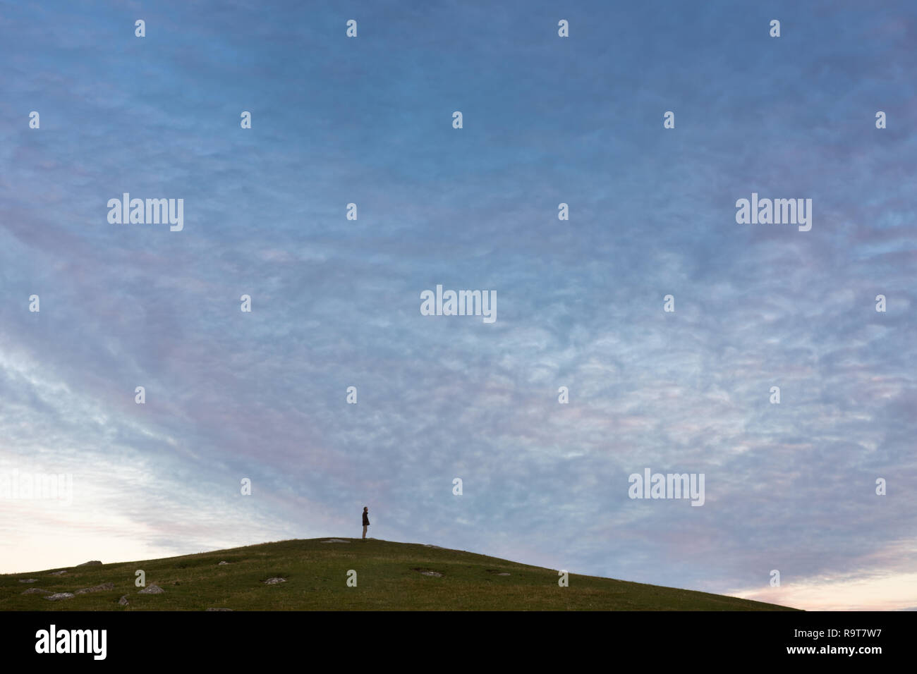 Single person standing on a hilltop in the evening on Fair Isle Stock ...