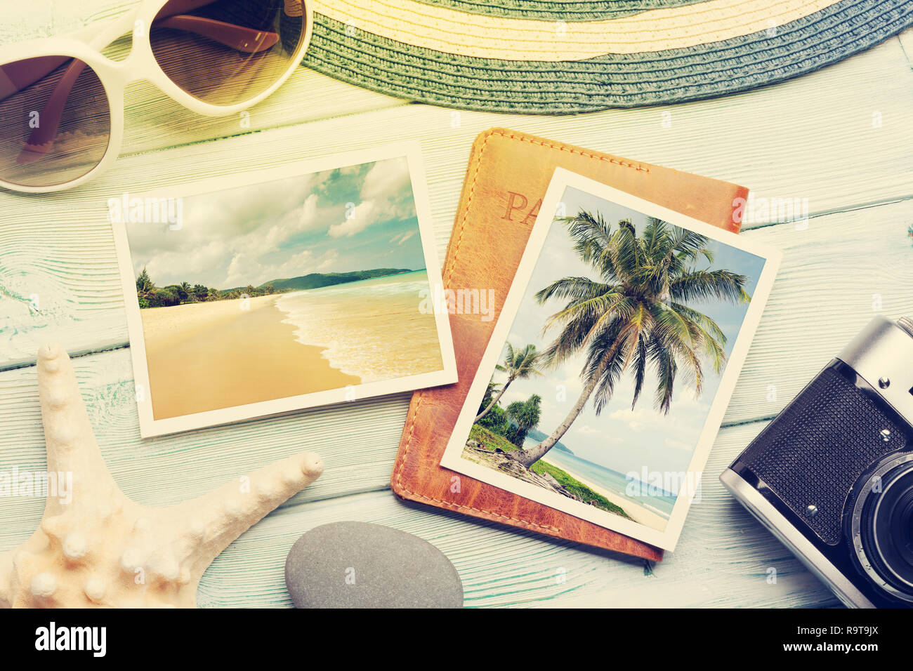 Travel vacation table concept with camera, passport and summer photos ...