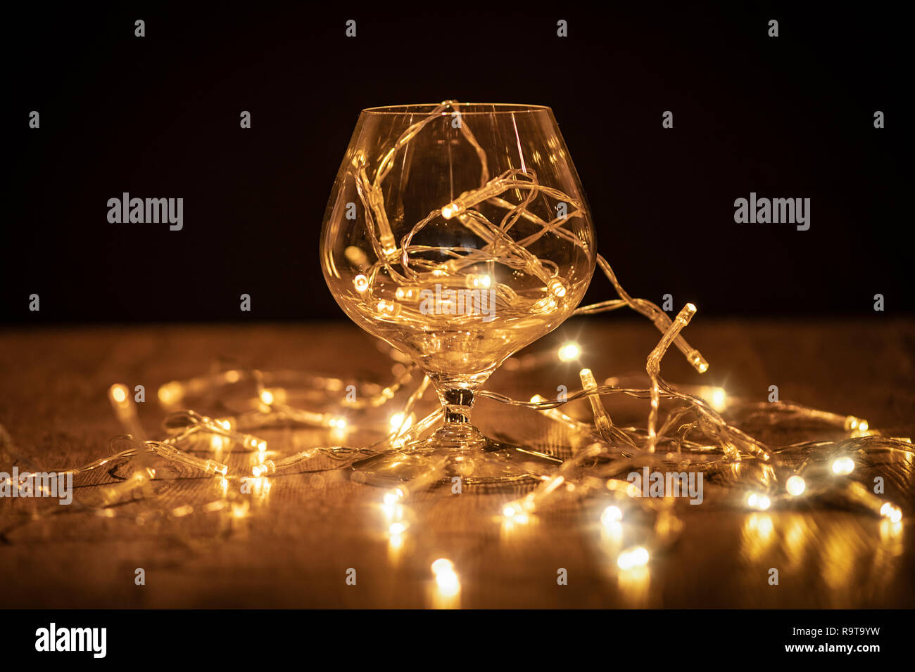 brandy glass with fairy lights, celebration Stock Photo - Alamy