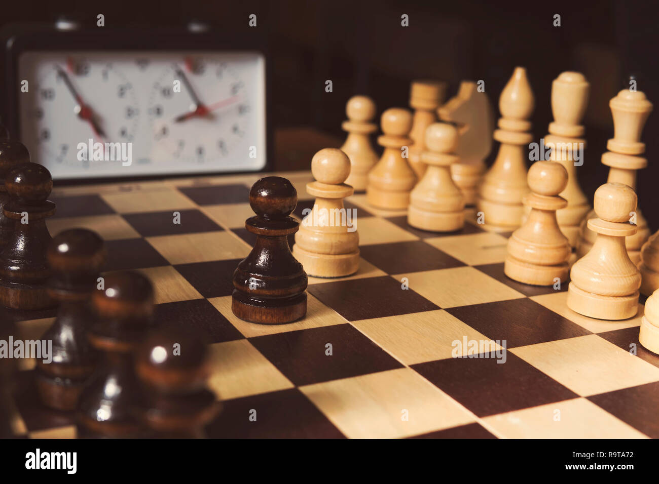 old chess clock on the chessboard with figures ,flag in position which ...