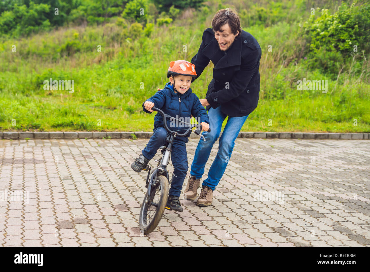 Father teaches son ride bicycle hi-res stock photography and images - Alamy