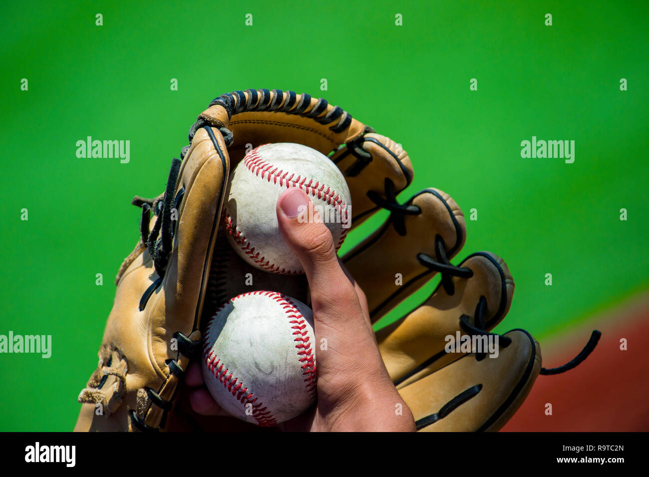baseball player holding balls in hand and mitt to pitch Stock Photo - Alamy