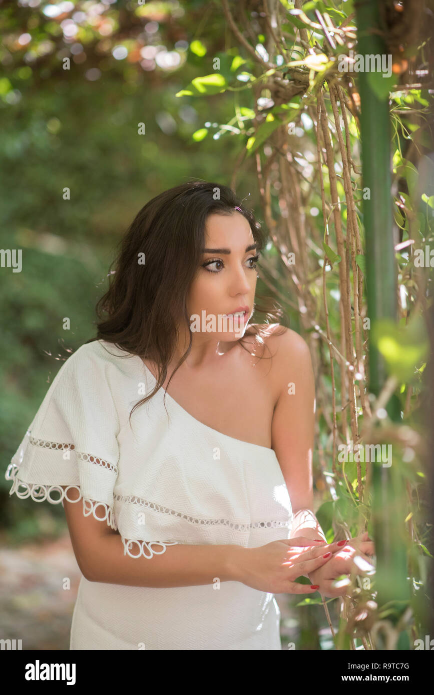 Scared young woman standing outdoors looking away Stock Photo - Alamy