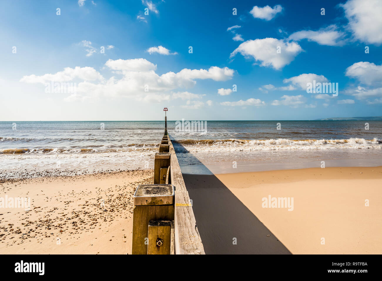 Calm waves on sunny beach hi-res stock photography and images - Alamy