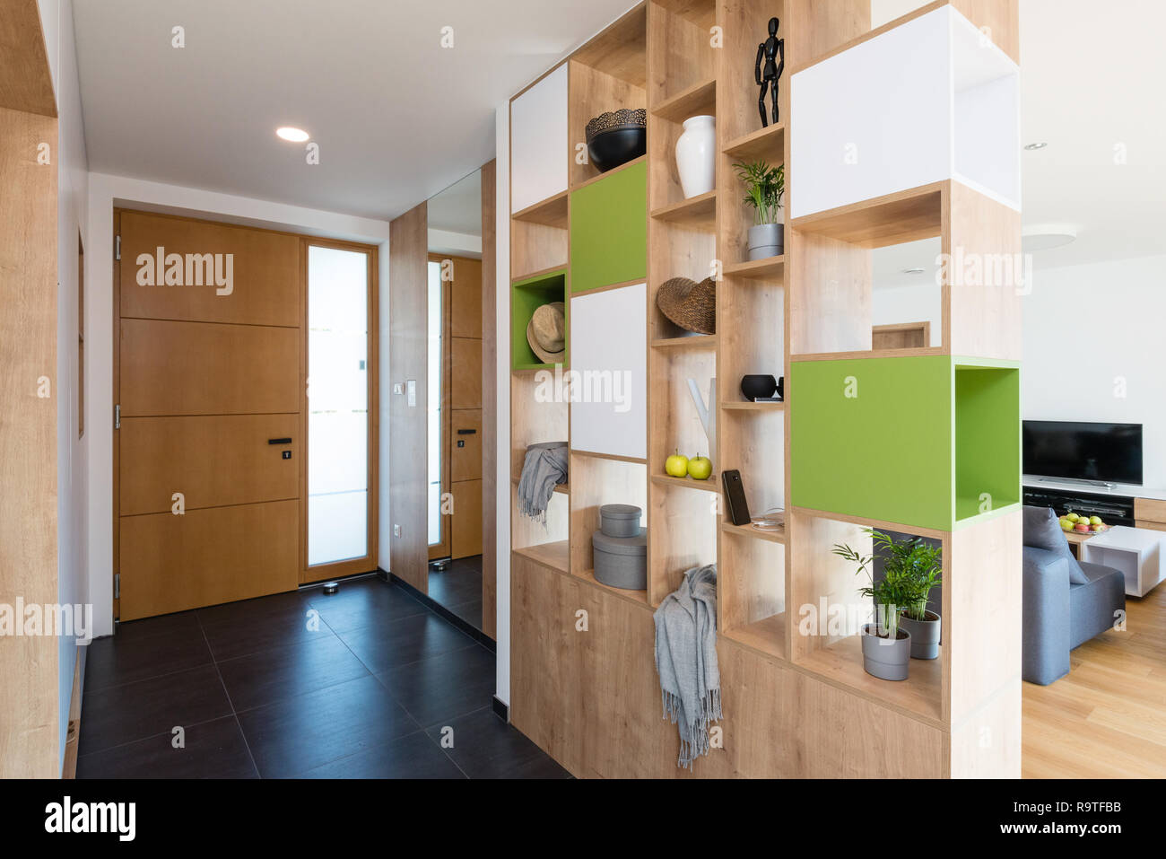 Custom made colorful wooden shelves in the hall of modern house Stock ...
