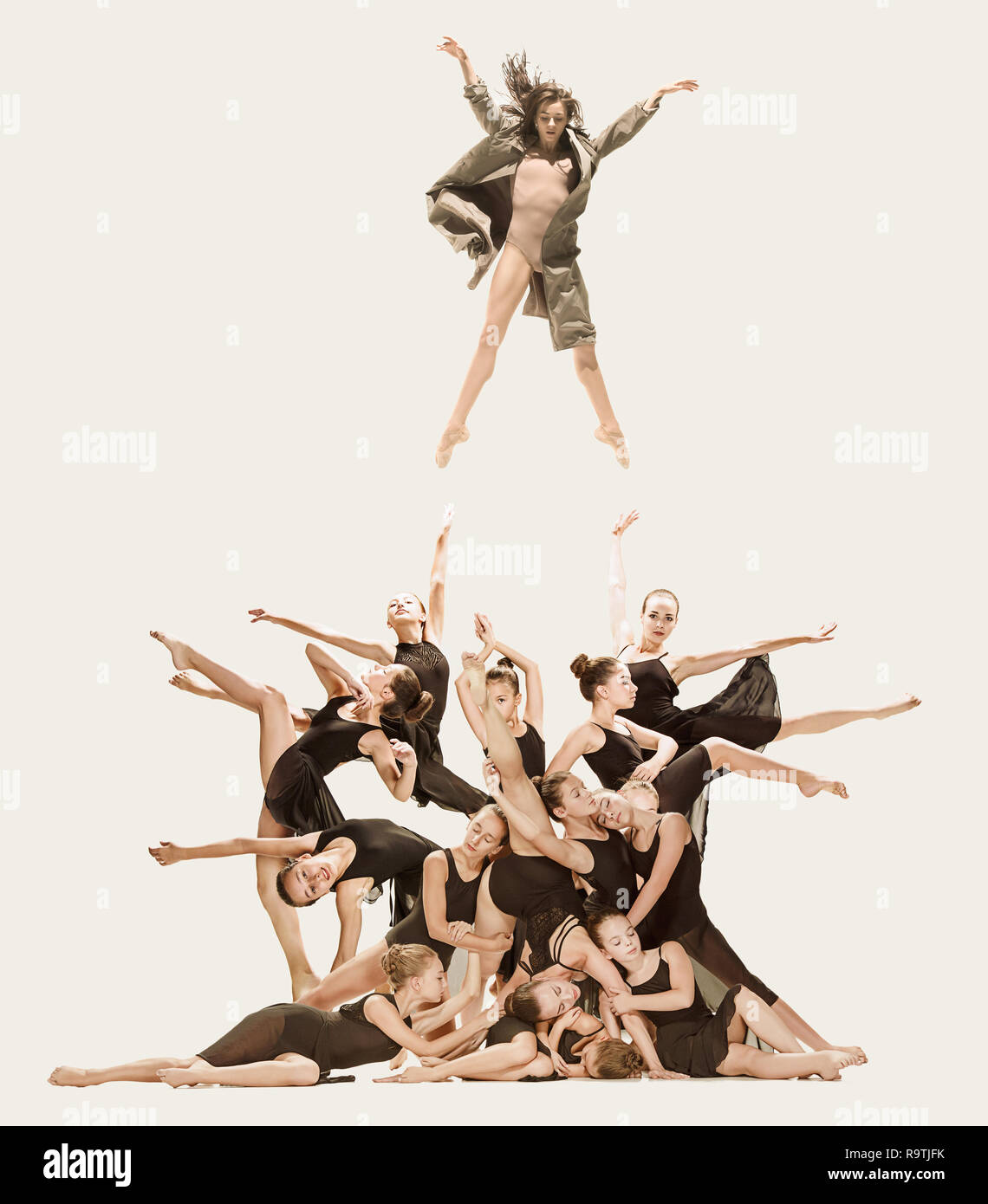 The group of modern ballet dancers dancing on gray studio background ...