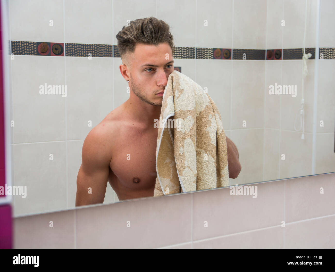 Shirtless muscular handsome young man in bathroom Stock Photo - Alamy