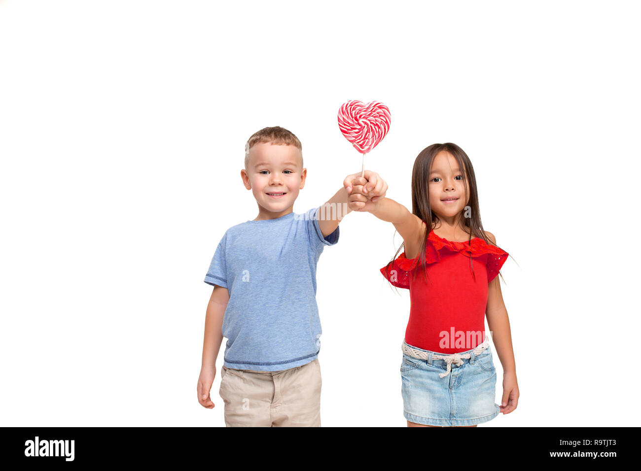 Full length portrait of cute little kids girl and boy in stylish ...