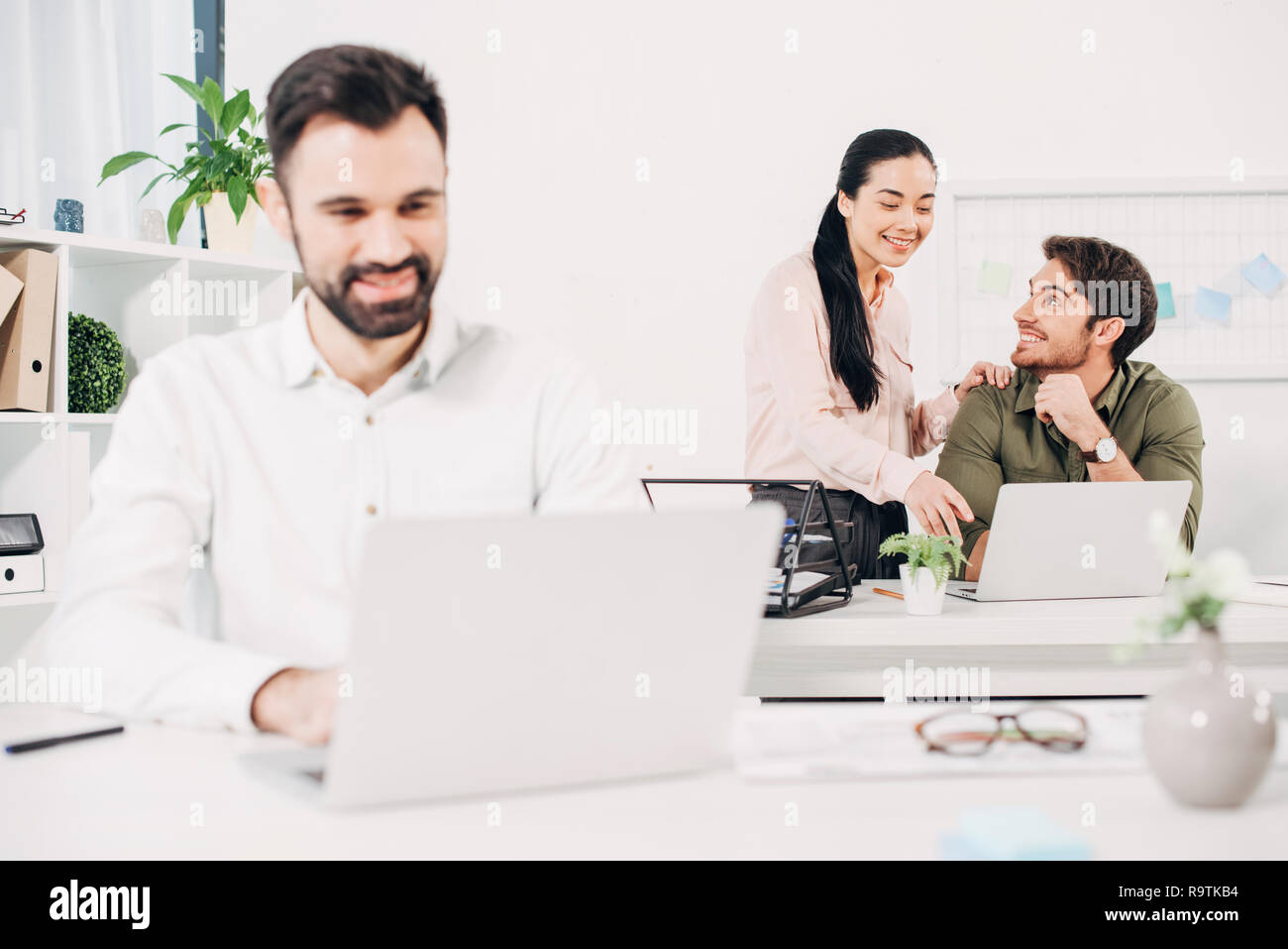 Cheerful colleagues smiling in modern office Stock Photo - Alamy