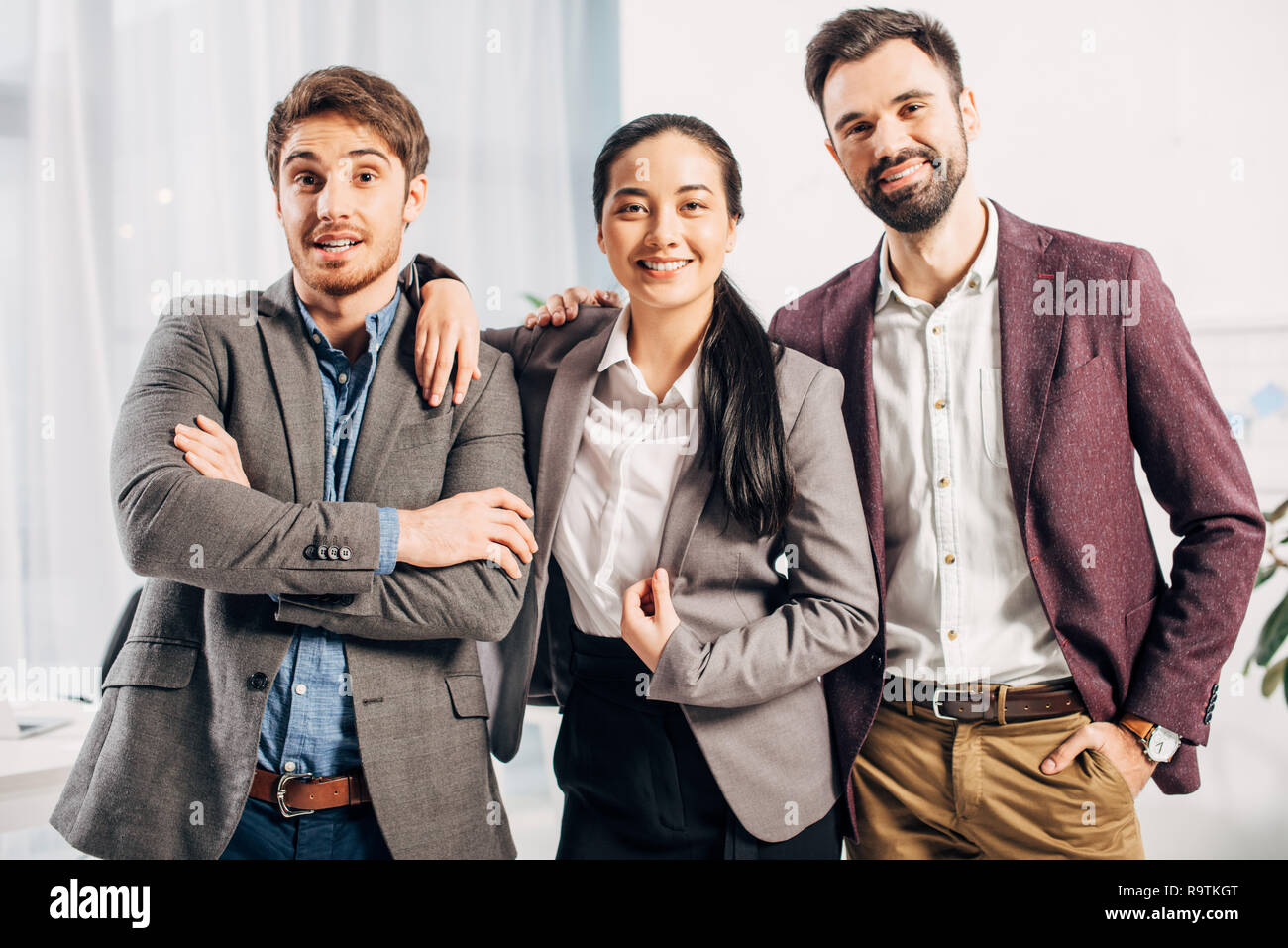 happy office managers looking at camera and smiling in office Stock ...