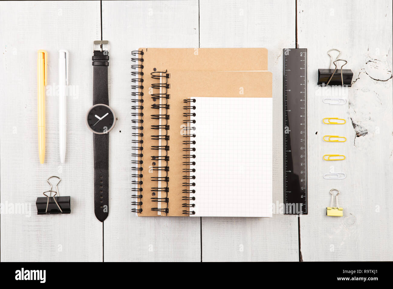 Workplace with notepad, watch and other office supply on a desk. Top ...