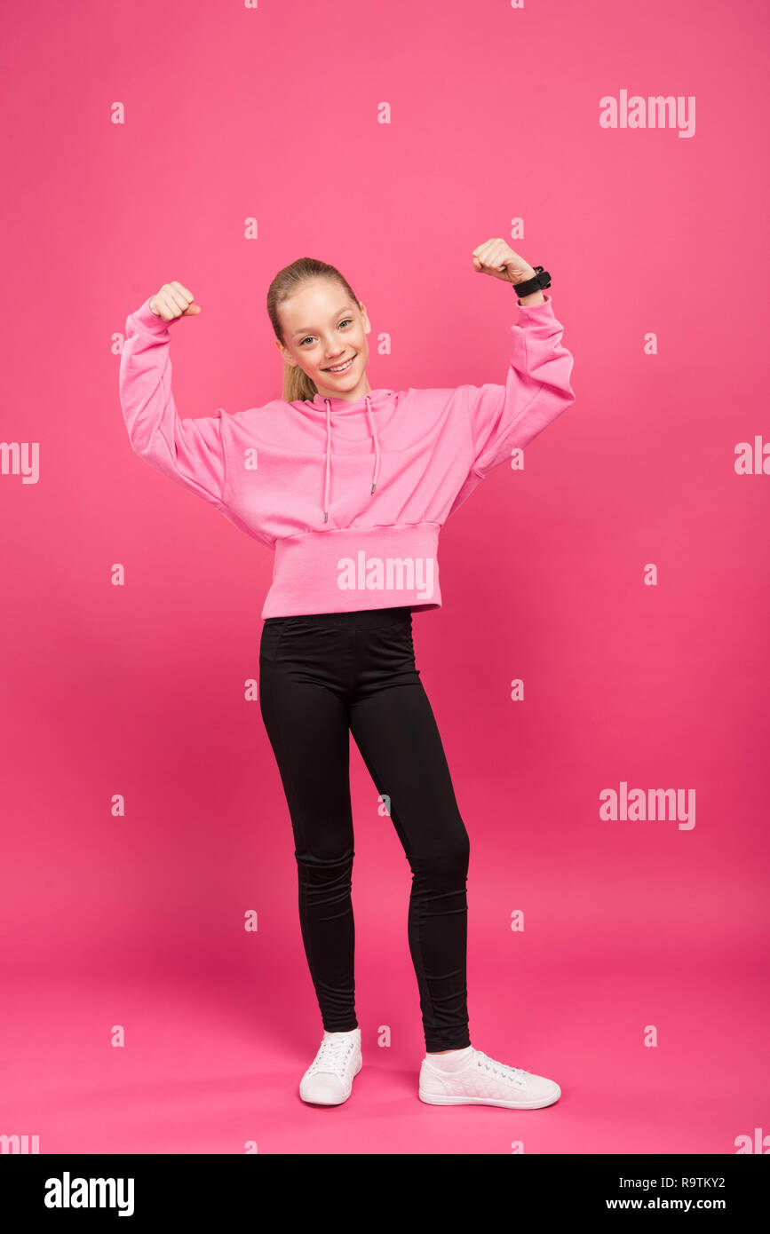 strong athletic kid showing muscles and biceps, isolated on pink Stock ...