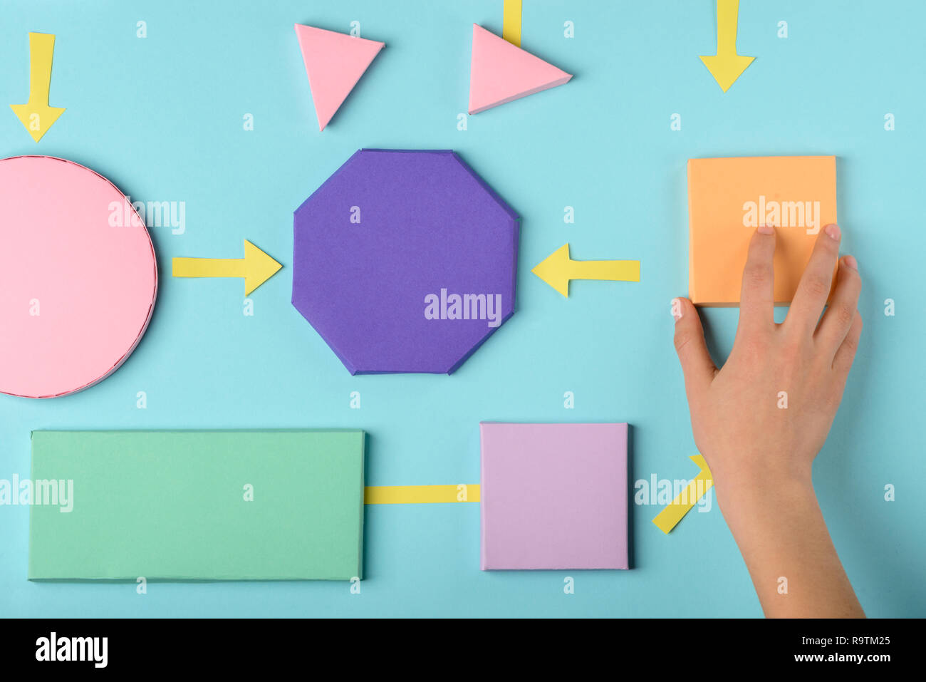 Woman making a diagram using color paper blocks. Beautiful workflow ...