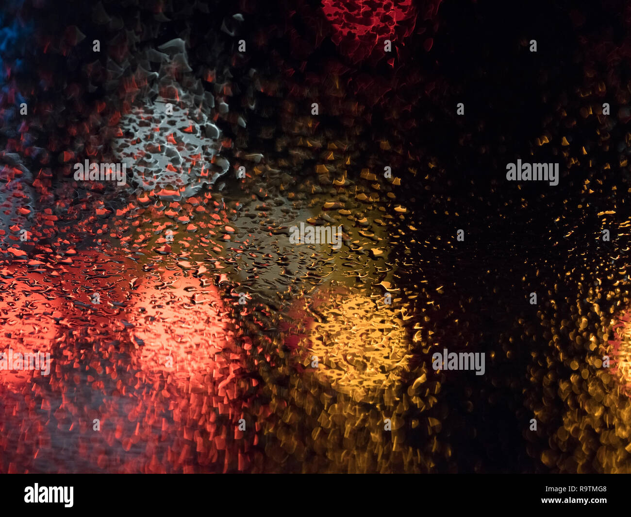 abstract pattern of colorful lights and rain drops during downpour on ...