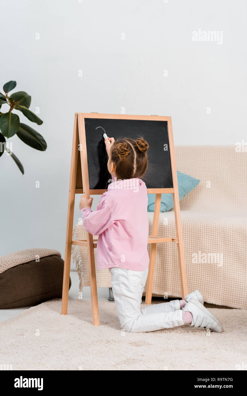Child kneeling rear view hi-res stock photography and images - Alamy