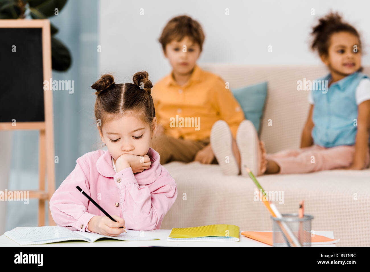 Child writing with pencil hi-res stock photography and images - Alamy