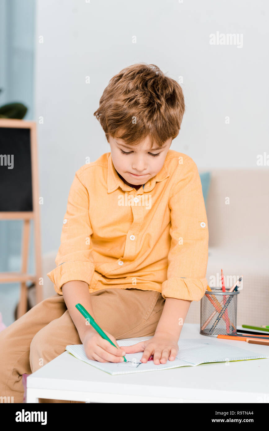 focused little boy writing and studying at home Stock Photo - Alamy