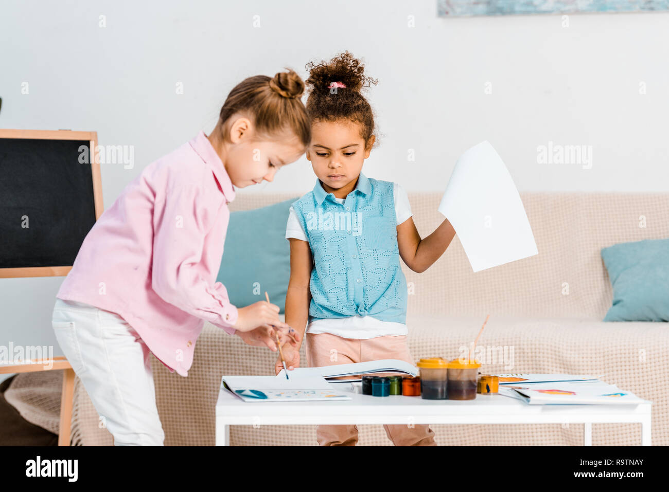 adorable focused multiethnic children painting together Stock Photo - Alamy