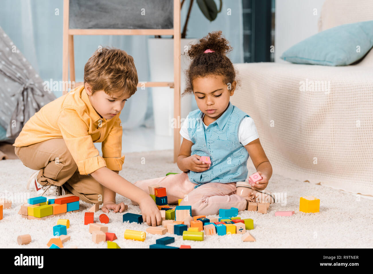 Adorable kids playing together blocks hi-res stock photography and ...