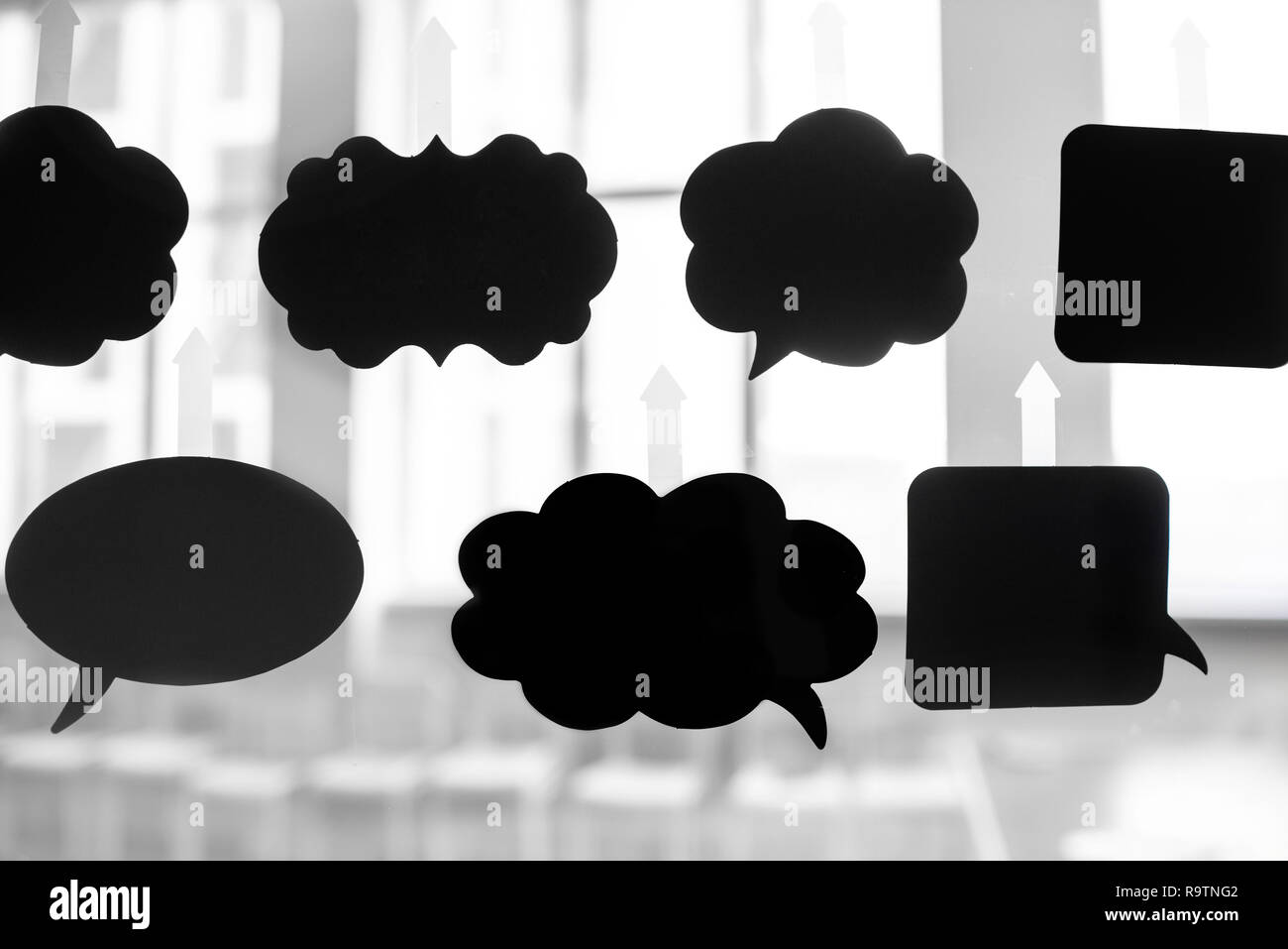 Black stickers in form of clouds with empty space on the glass wall in ...