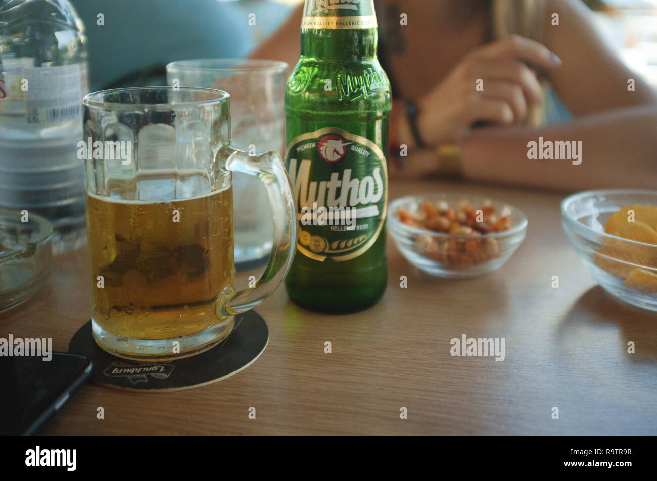 drinking mythos beer in bar in agios nikolaos, crete, greece Stock ...