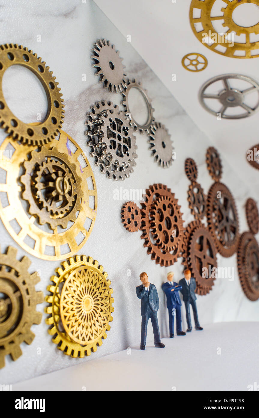 Businessmen surrounded by gears and cogs for innovation conceptual ...