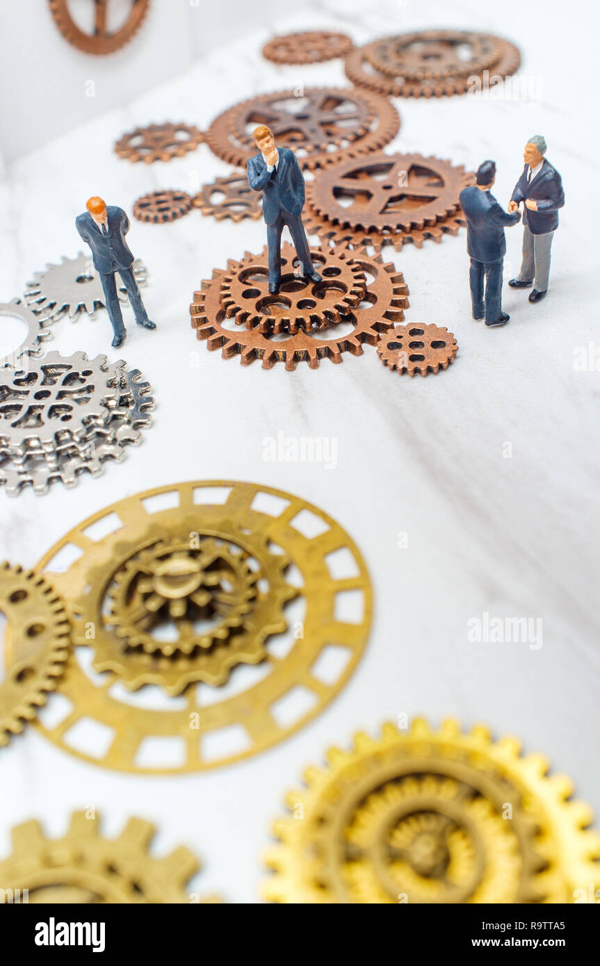Businessmen surrounded by gears and cogs for innovation conceptual ...