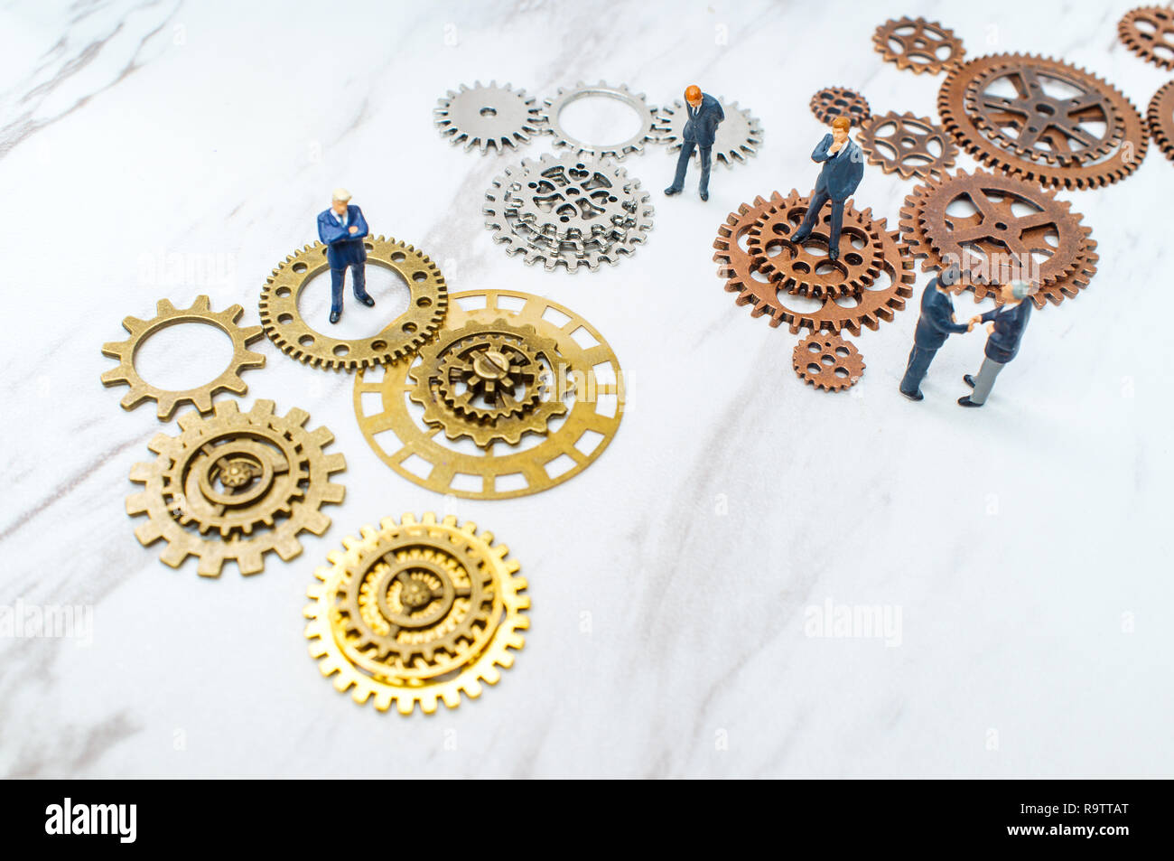Businessmen surrounded by gears and cogs for innovation conceptual ...