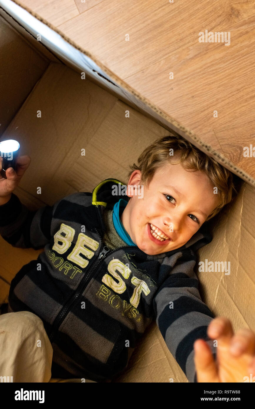 Child playing inside a cardboard box Stock Photo - Alamy