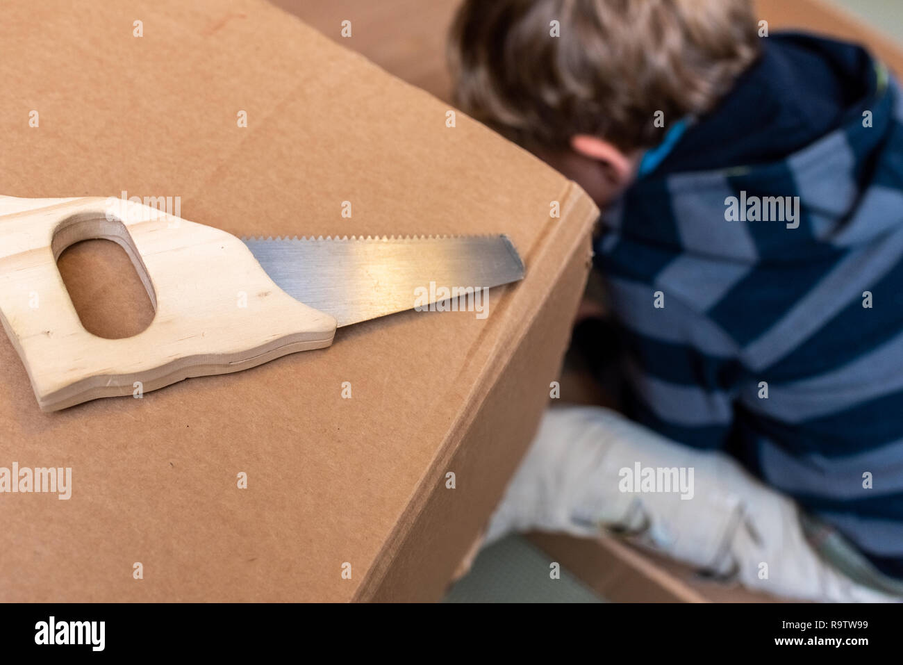 Child playing with a real carpenter saw Stock Photo - Alamy