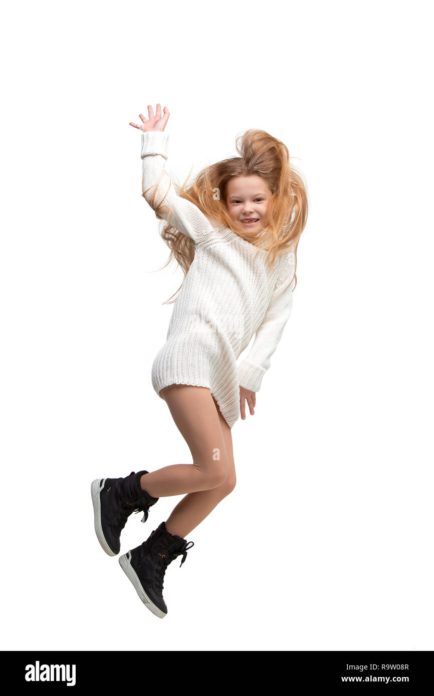 Cute little girl jump. Studio shot. White background. Kids fashion ...