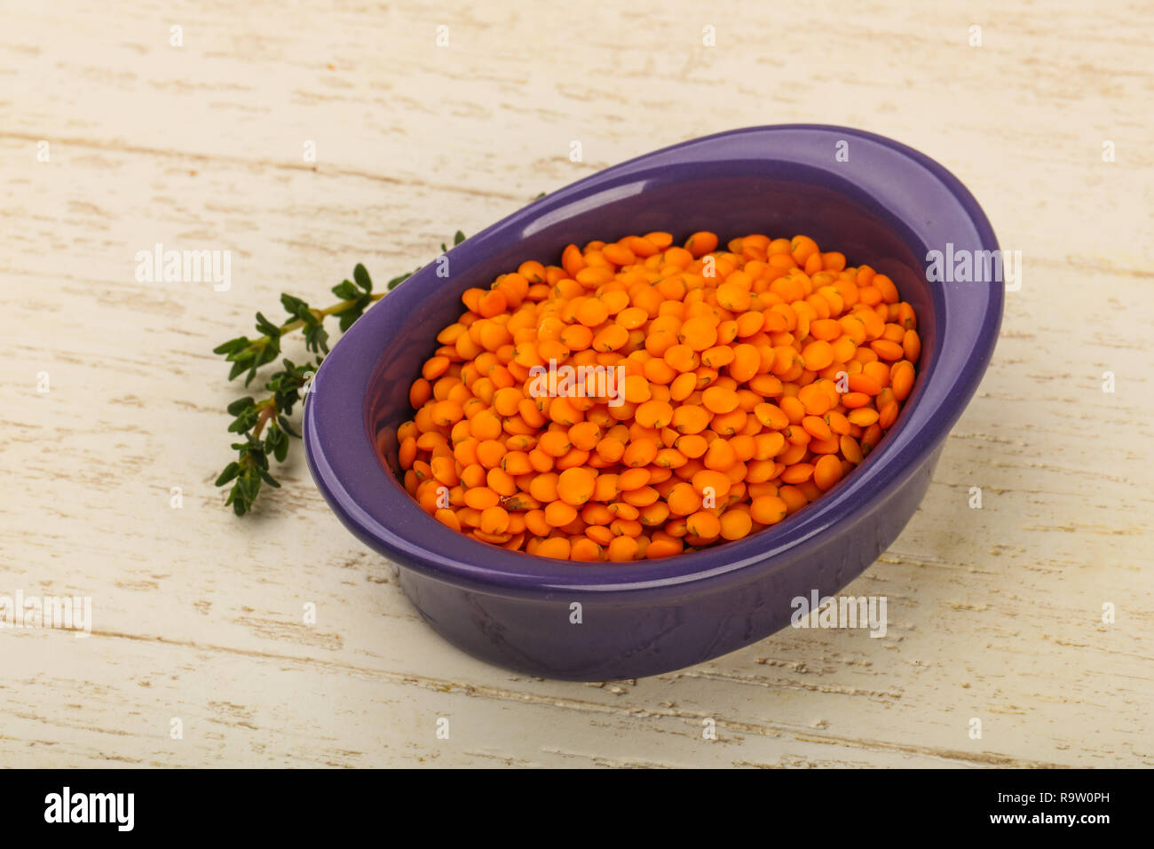 Orange lentil in the bowl over wooden background Stock Photo - Alamy
