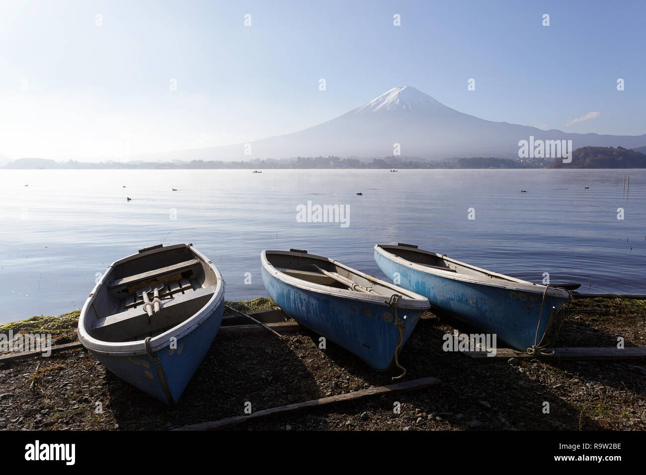 Small blue boats beside a Lake, with Mount Fuji behind, Central Honshu ...