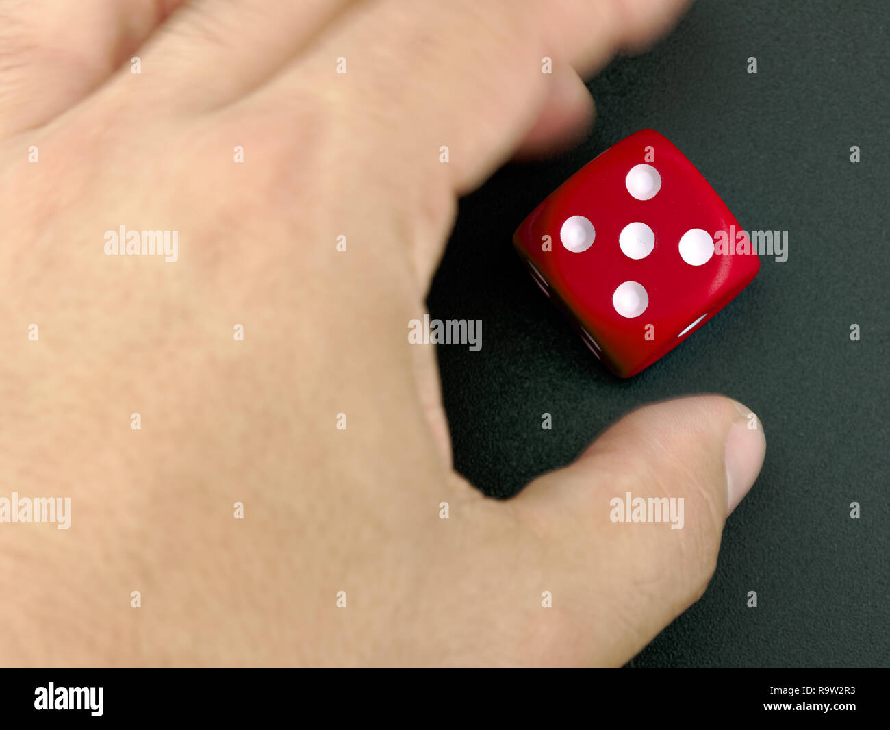Closeup hand playing with dice Stock Photo - Alamy