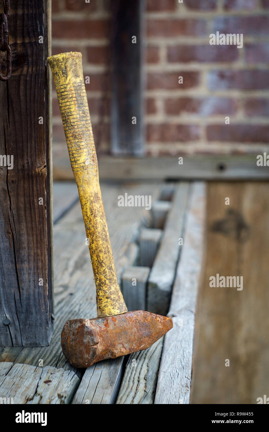 Small single handed worn and rusty sledge hammer construction ...